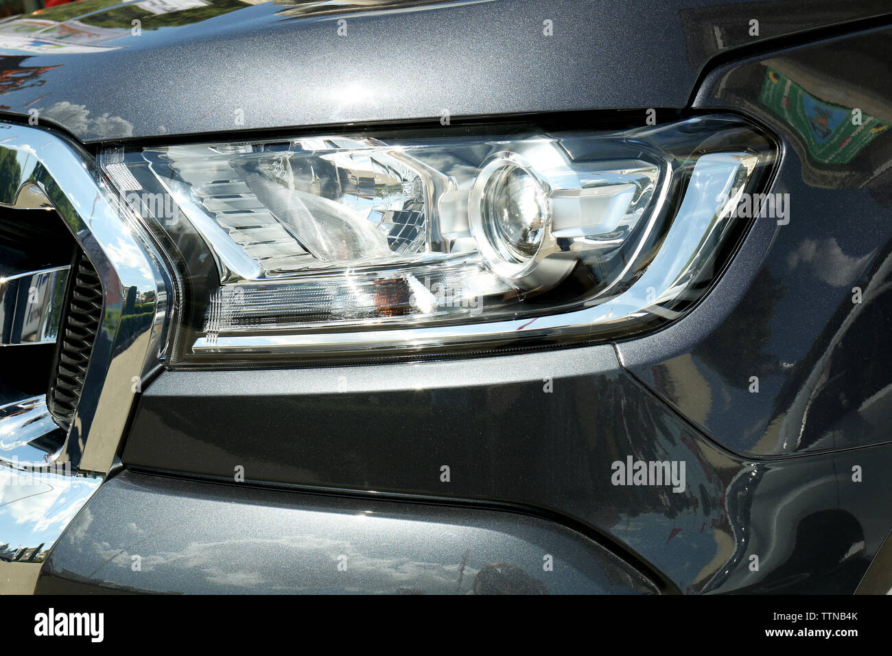 Modern car headlight Stock Photo - Alamy