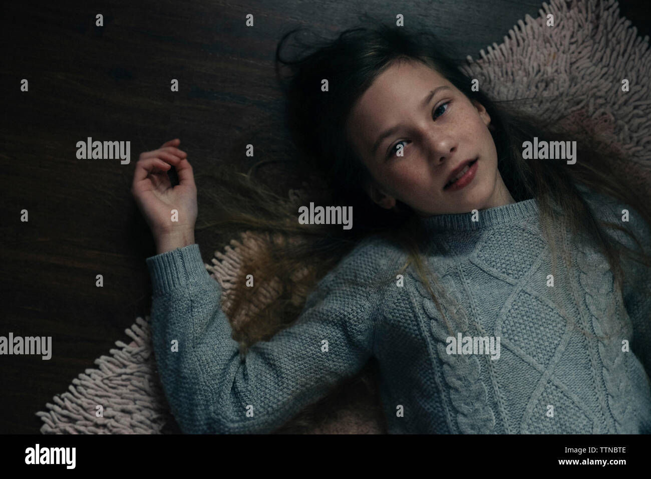 High angle portrait of girl lying on rug at home Stock Photo - Alamy