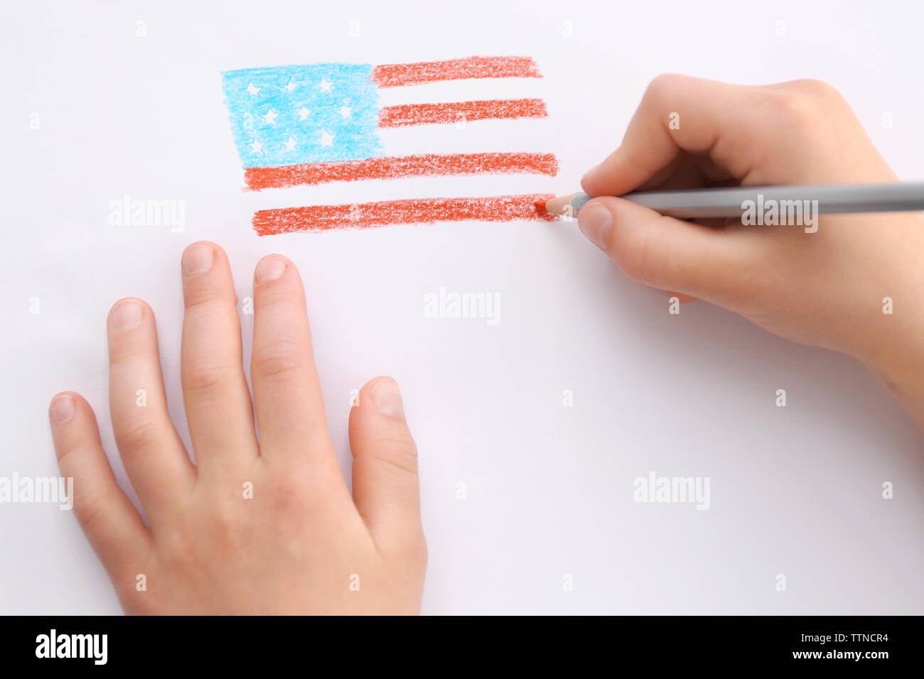 Child's hands drawing American flag on paper Stock Photo - Alamy