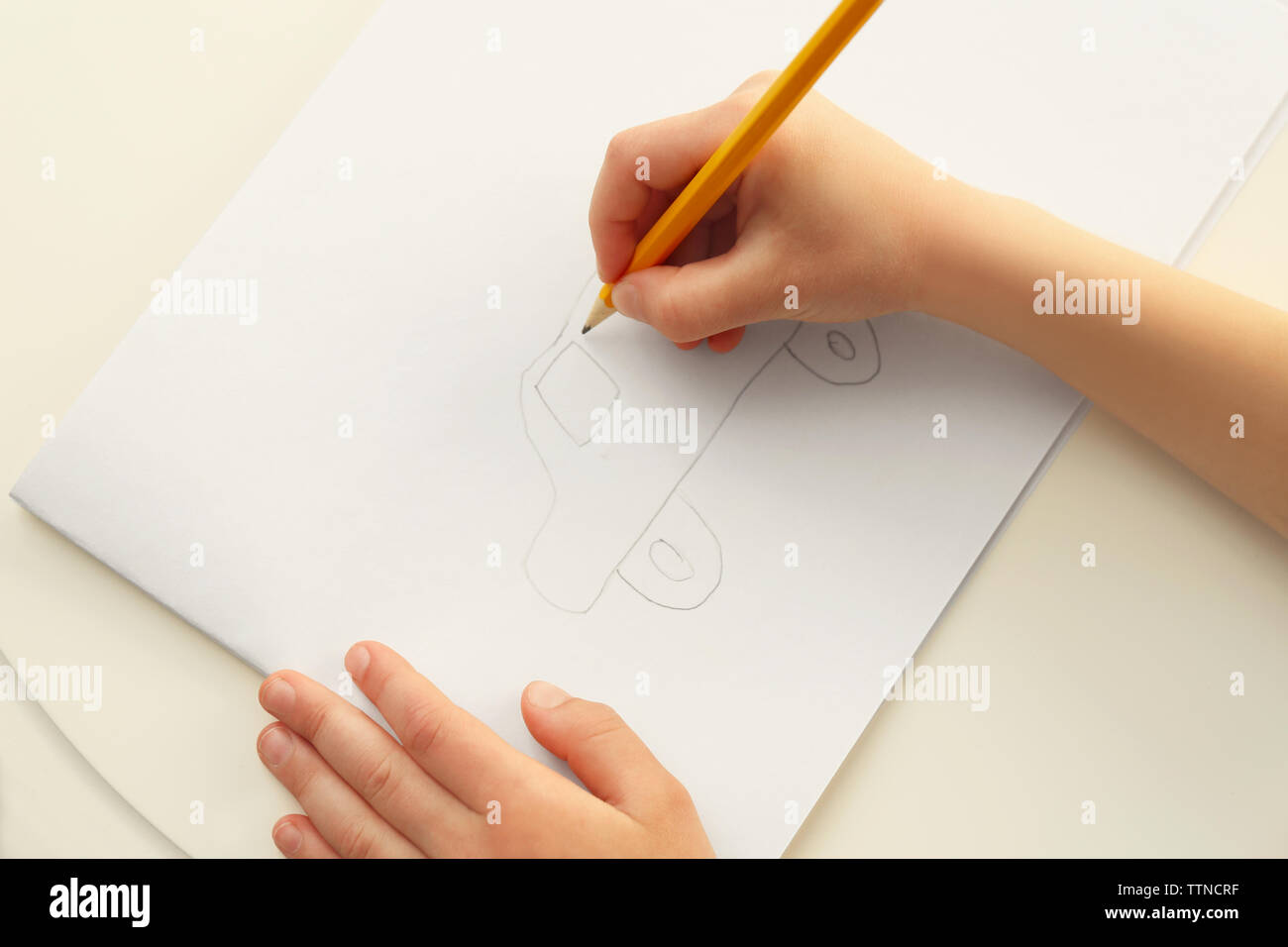 Child's hand drawing picture on paper Stock Photo - Alamy