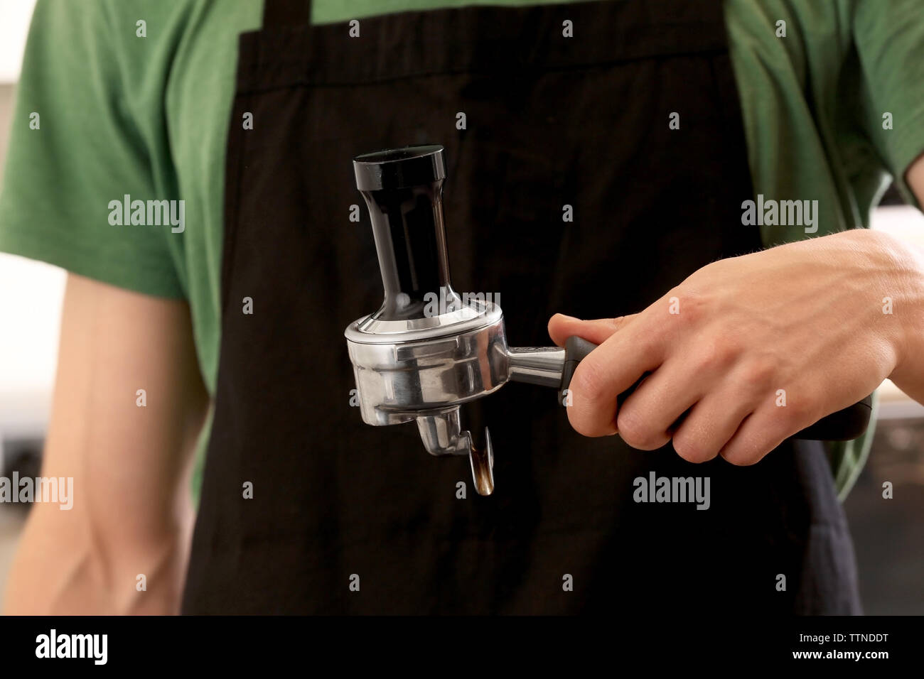 Male barista holding tamper hi-res stock photography and images - Alamy