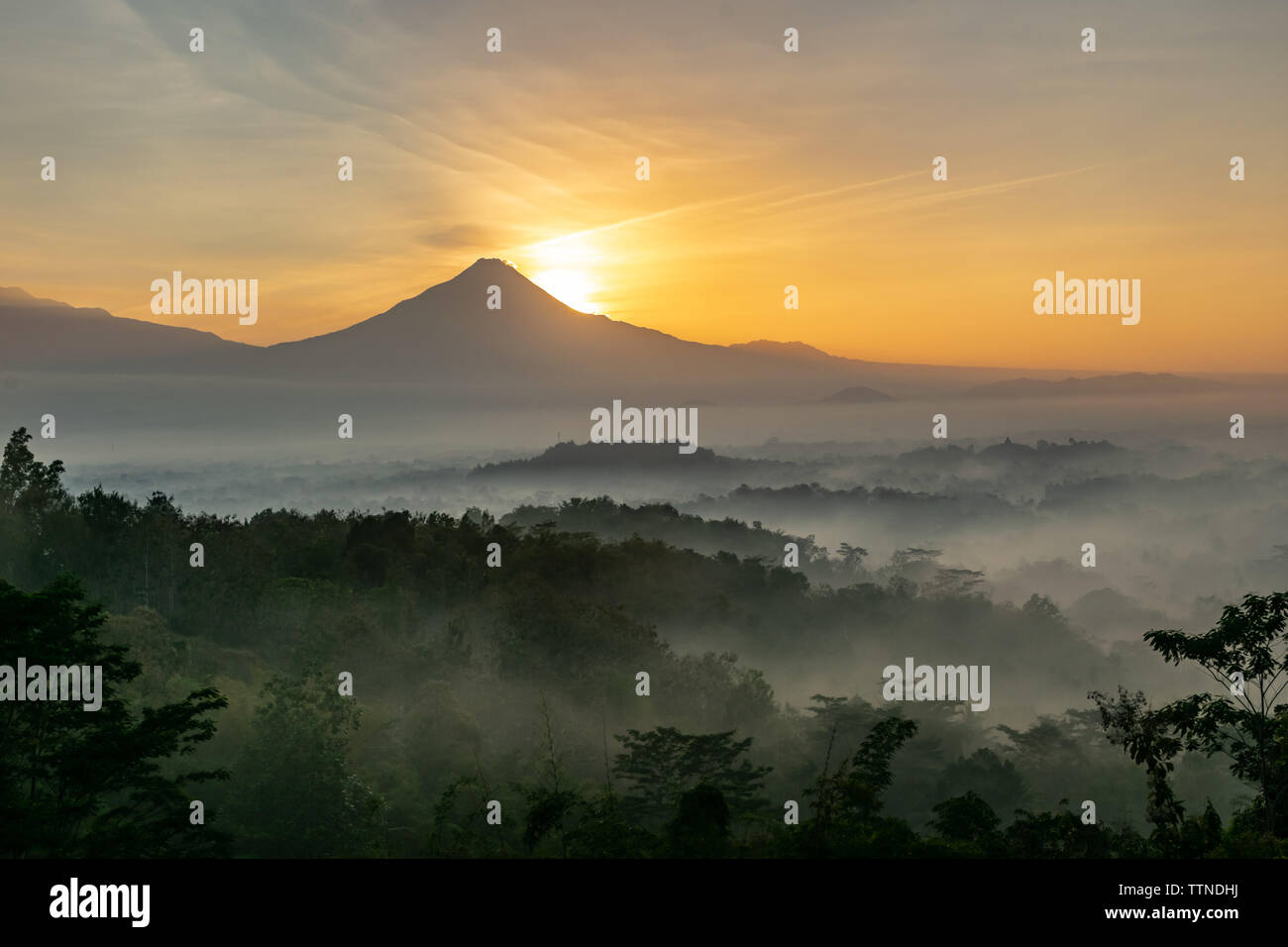 Beautiful foggy sunrise behind Merapi Volcano Stock Photo - Alamy