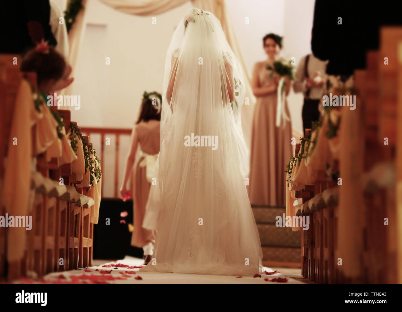 Beautiful bride walking to wedding altar Stock Photo - Alamy