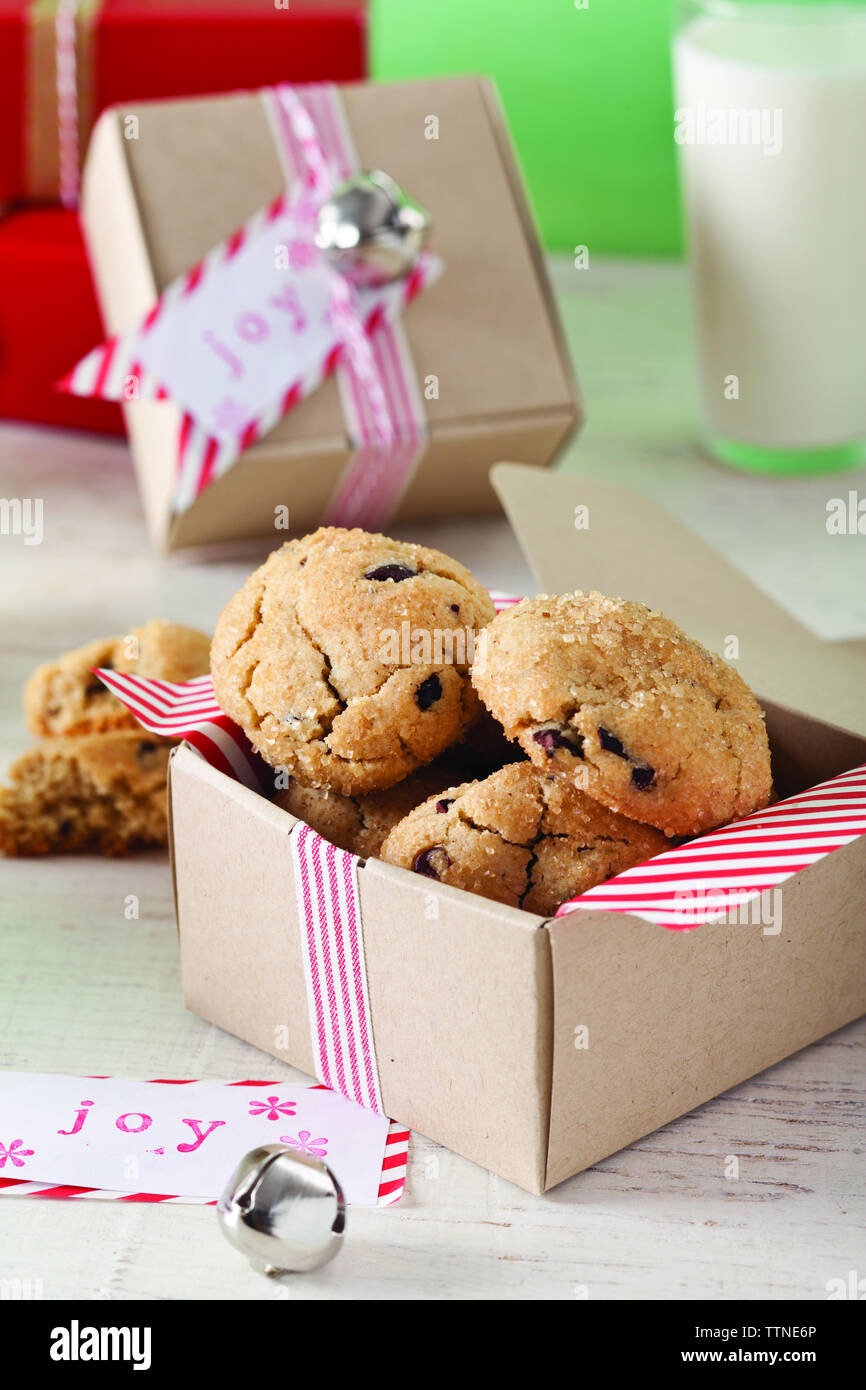 High angle view of chocolate chip cookies in cardboard box on wooden ...
