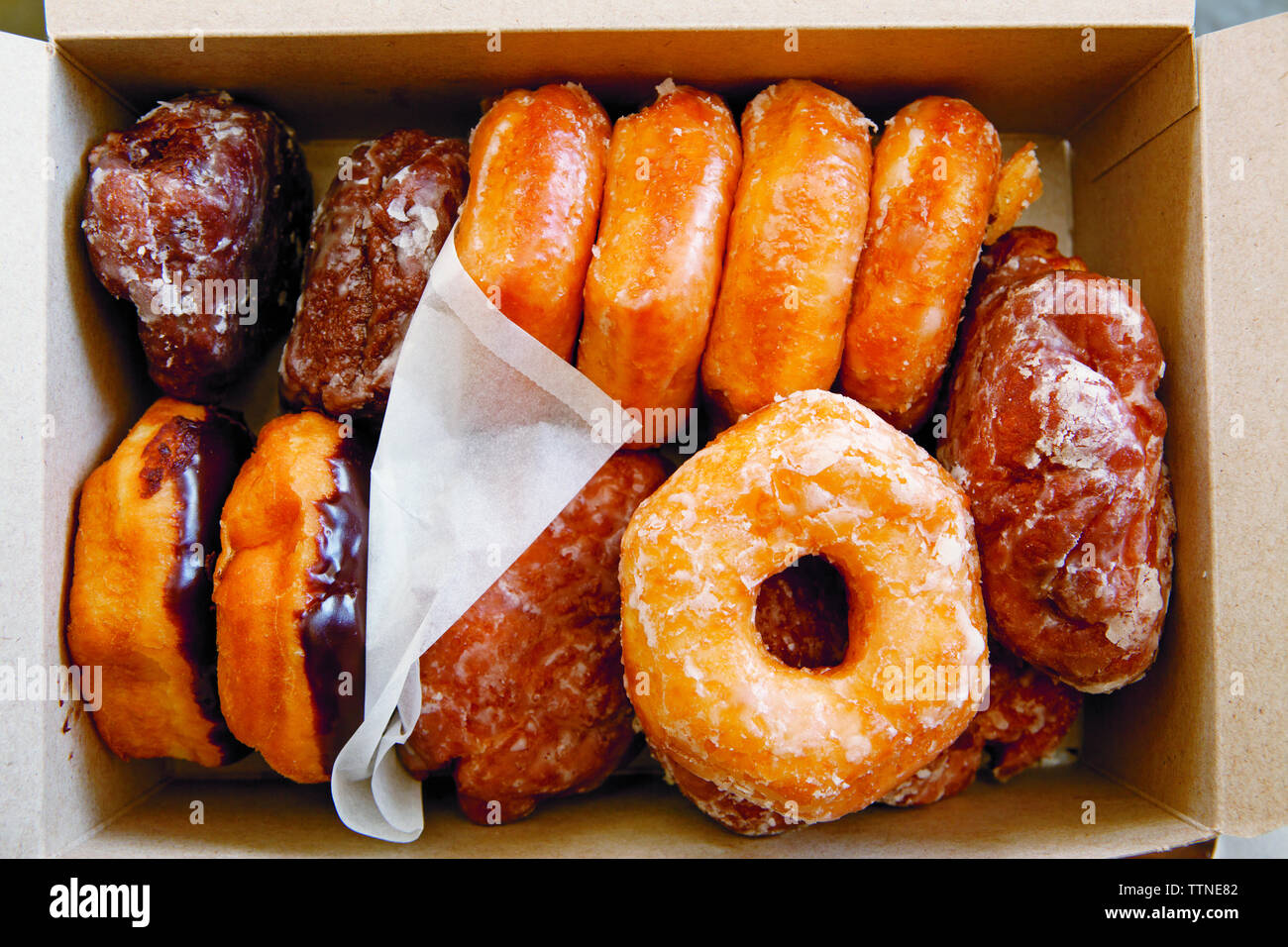 Overhead view of donuts in cardboard box Stock Photo - Alamy