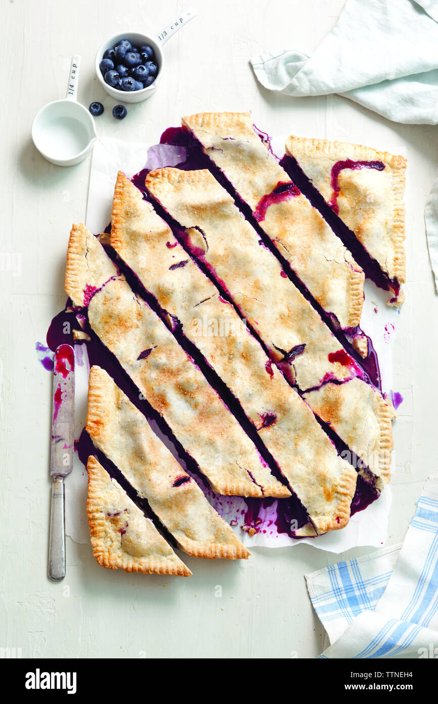Overhead view of sliced blueberry pie on table at home Stock Photo - Alamy