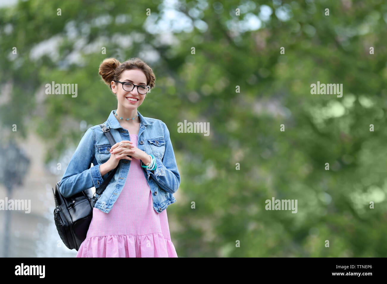 Beautiful young woman on blurred background Stock Photo - Alamy