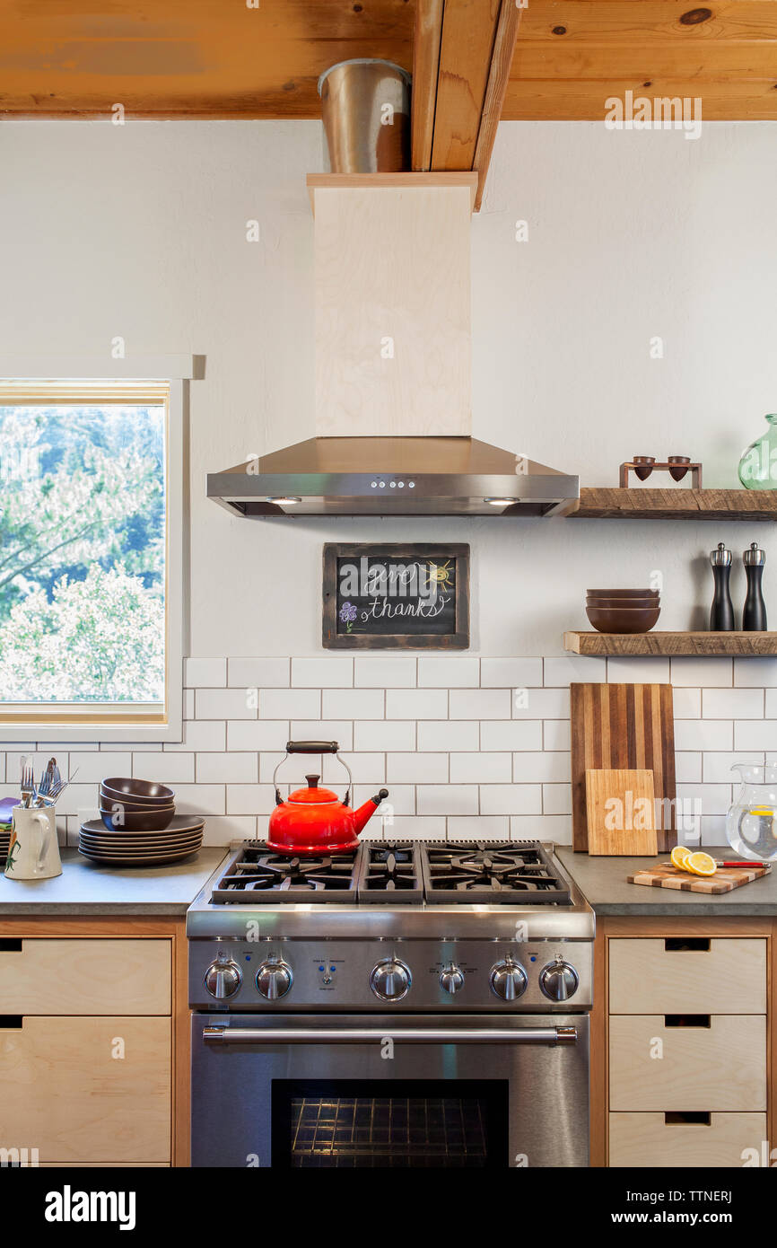 Tea kettle on stove in kitchen counter Stock Photo - Alamy