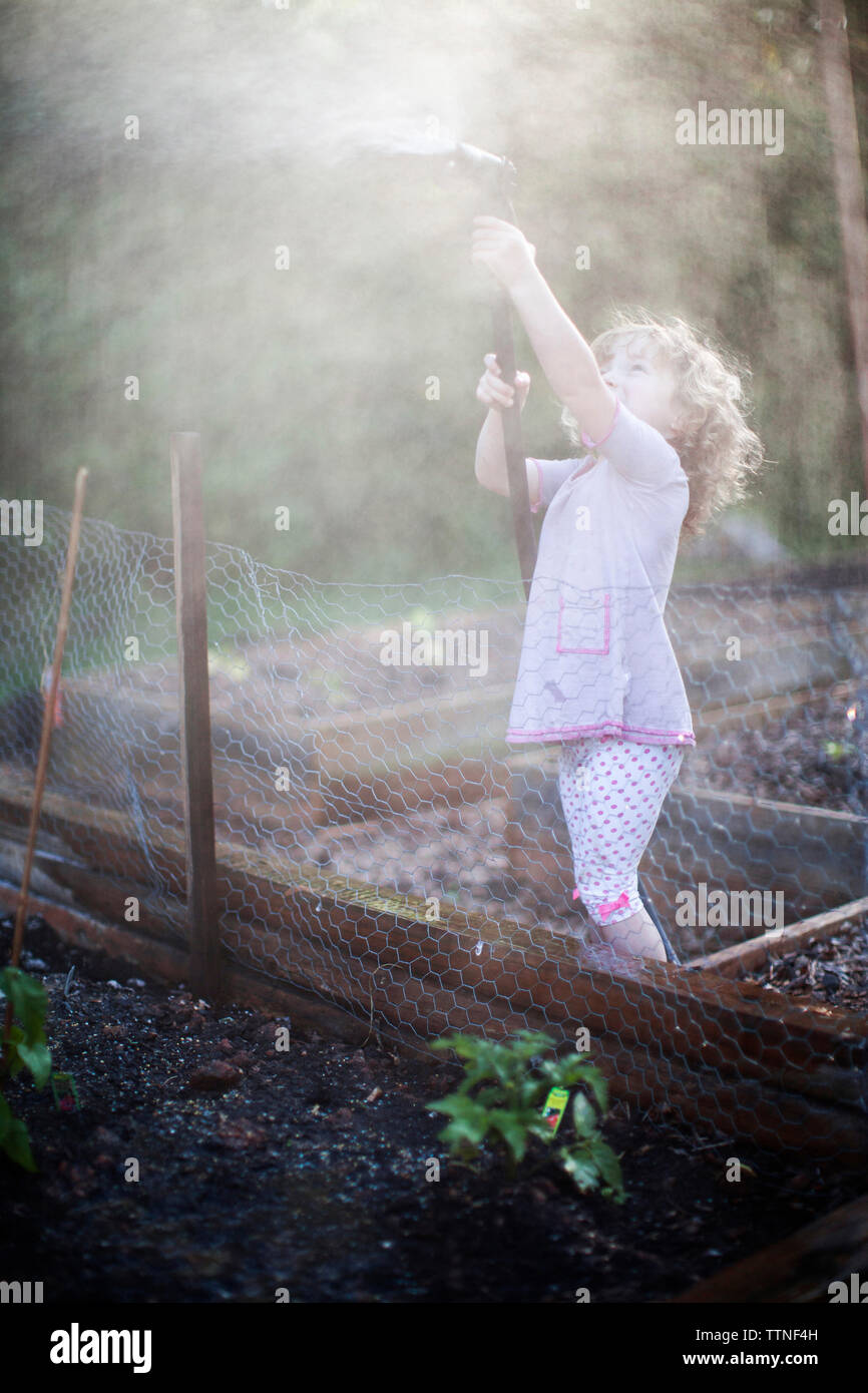 Girl holding water hose hi-res stock photography and images - Alamy