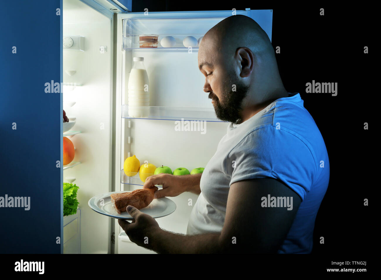 Man taking food from refrigerator Stock Photo - Alamy
