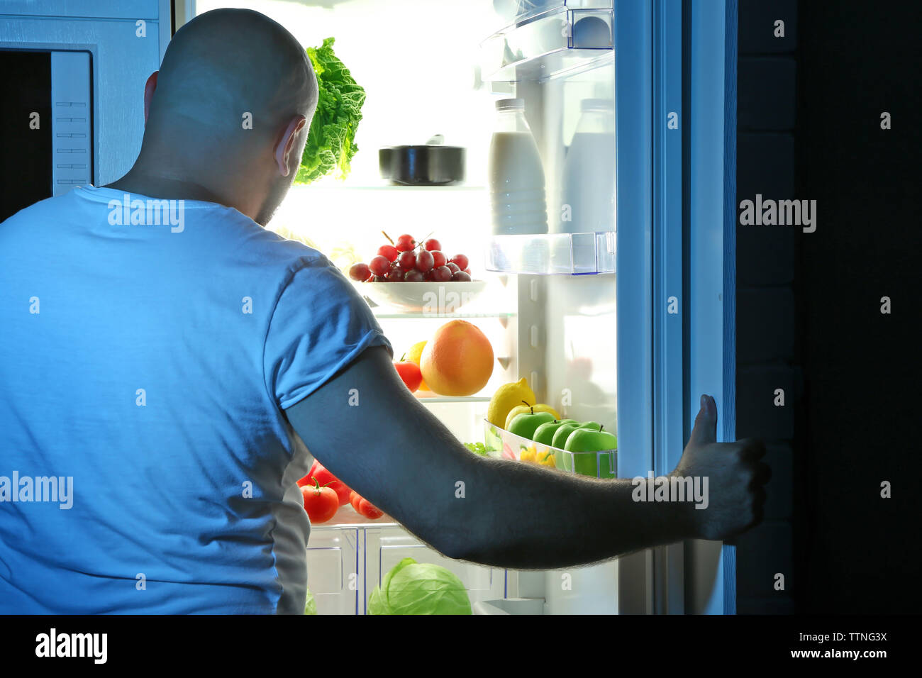 Man taking food from refrigerator Stock Photo - Alamy
