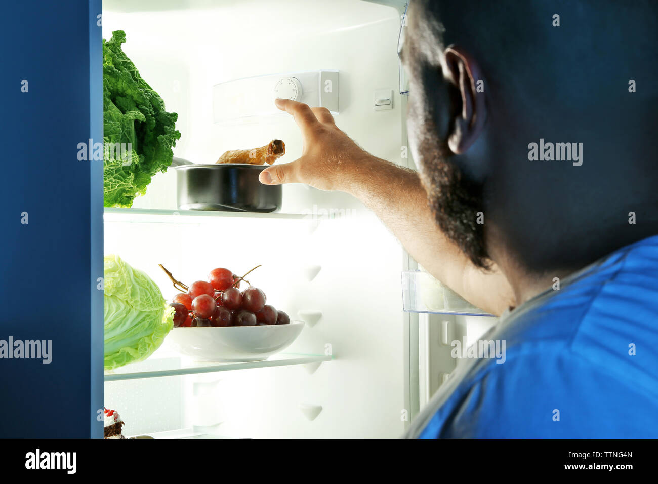 Man taking food from refrigerator Stock Photo - Alamy