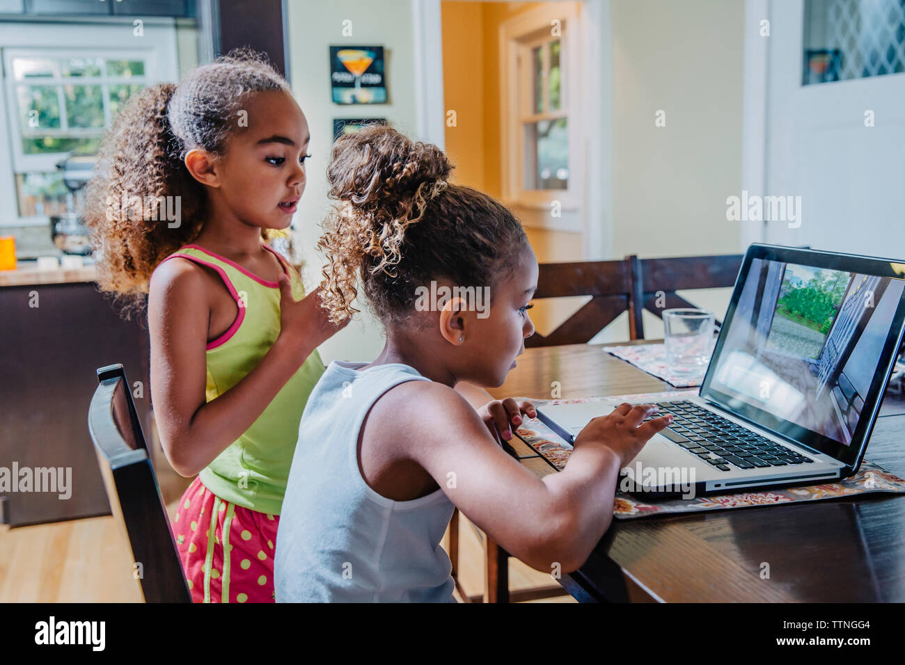 Two girls looking laptop hi-res stock photography and images - Alamy