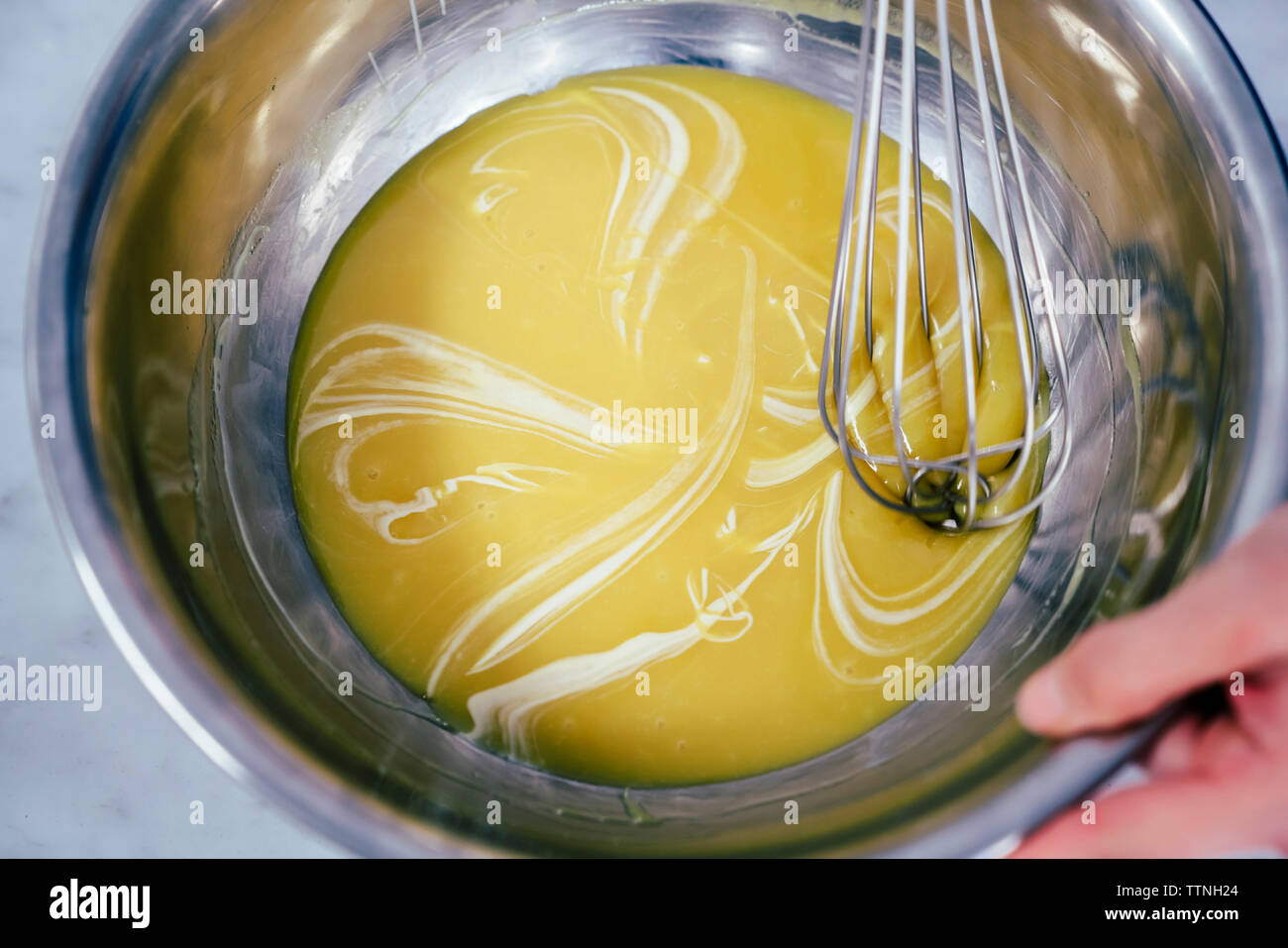 Cropped hand of chef mixing food in bowl at chocolate factory Stock ...