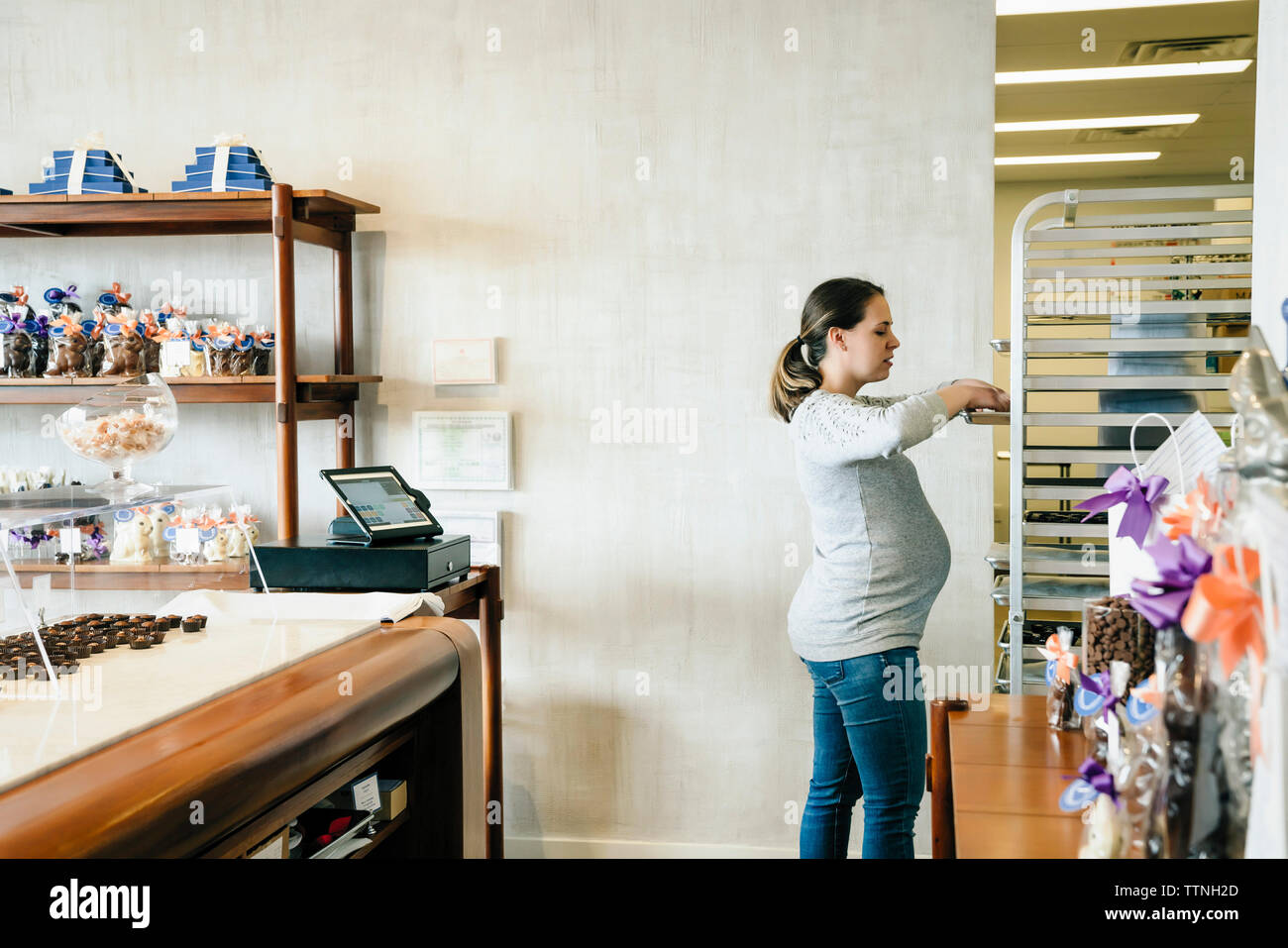 Side view of female owner working at store Stock Photo - Alamy