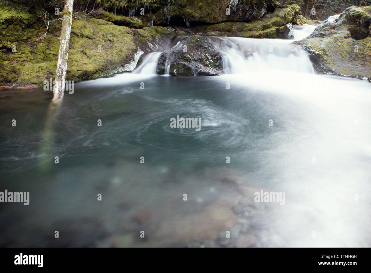 View of stream and waterfall Stock Photo - Alamy