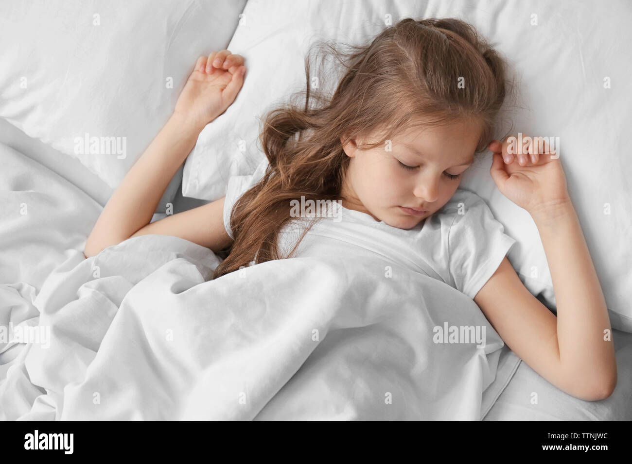Cute sleeping girl in white bed Stock Photo - Alamy