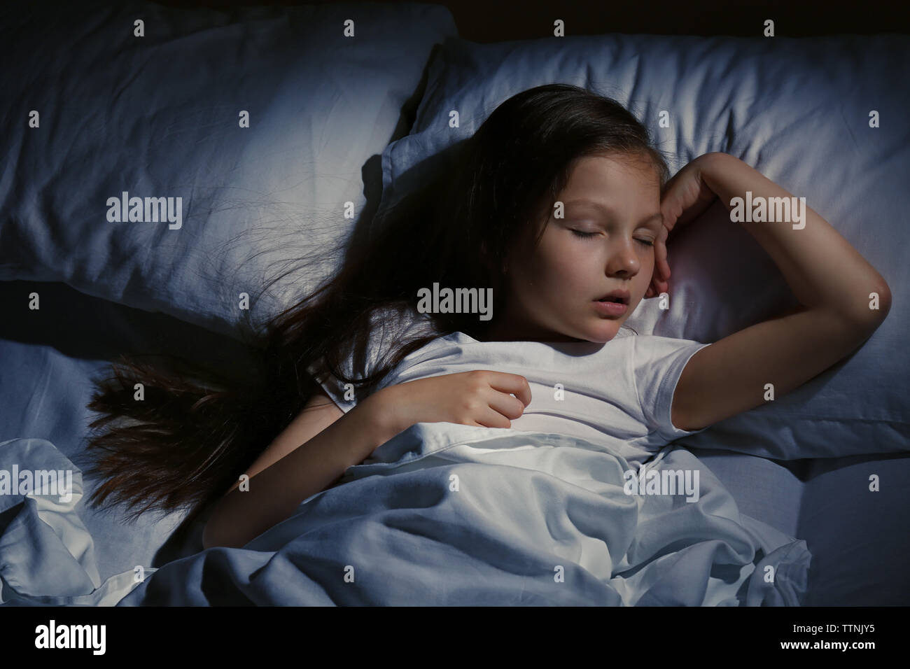Cute sleeping girl in bed Stock Photo - Alamy