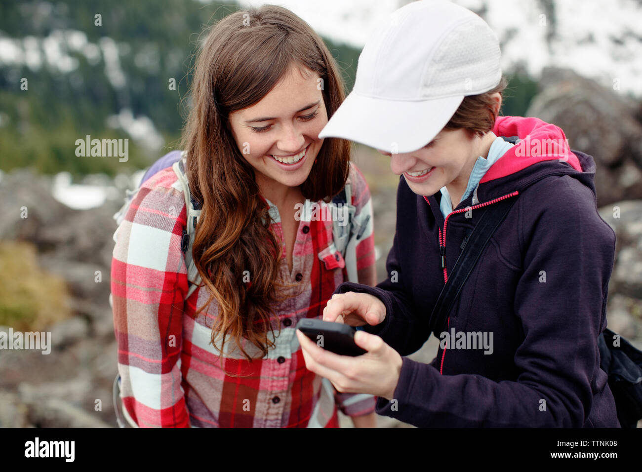 Women hikers using mobile phone hi-res stock photography and images - Alamy
