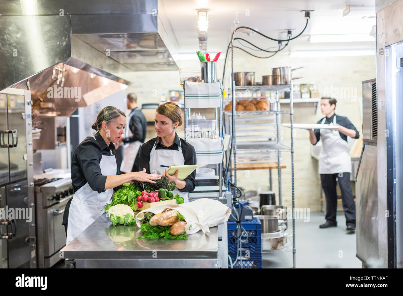Chefs working in restaurant kitchen Stock Photo - Alamy