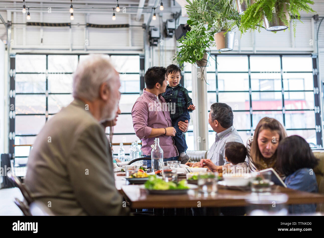 Children and parents enjoying in restaurant Stock Photo - Alamy