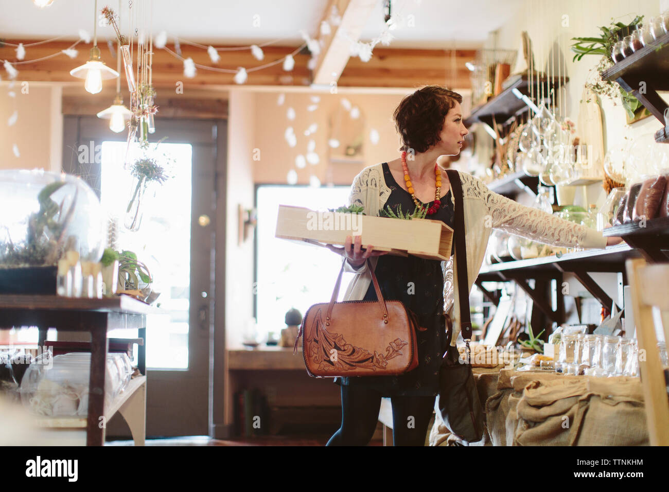 Customer examining plants in garden center Stock Photo - Alamy Customer examining plants in garden center Stock Photo - Alamy