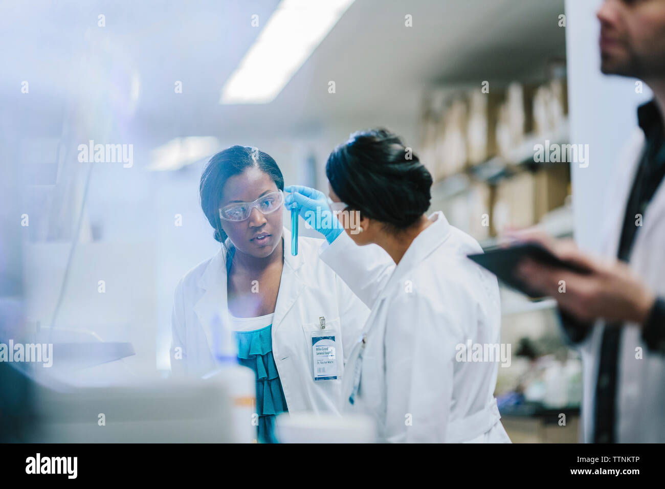 Female doctors examining test tubes in laboratory Stock Photo - Alamy