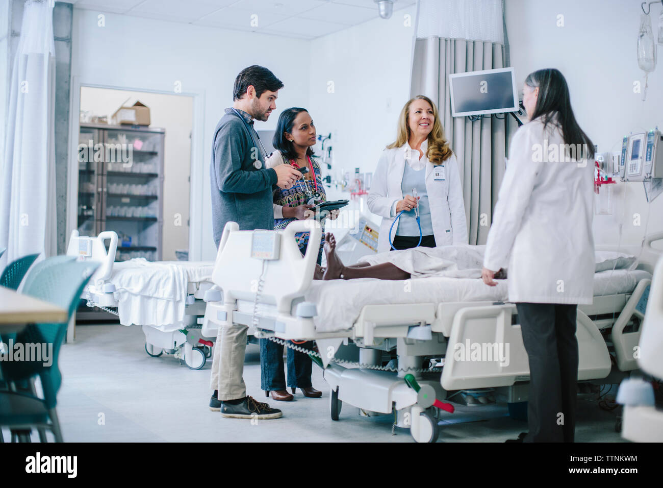 Female doctor training coworkers in medical school Stock Photo - Alamy