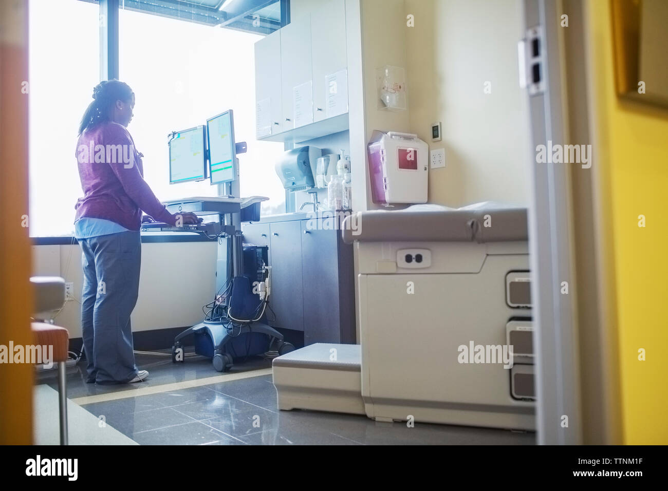 Female doctor using desktop computer in medical room Stock Photo - Alamy