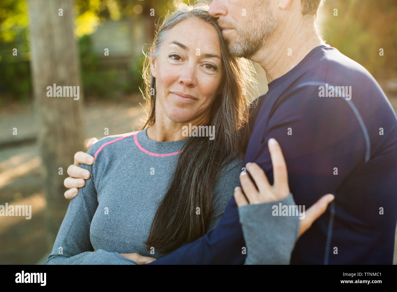 Portrait of woman being embraced by man Stock Photo - Alamy