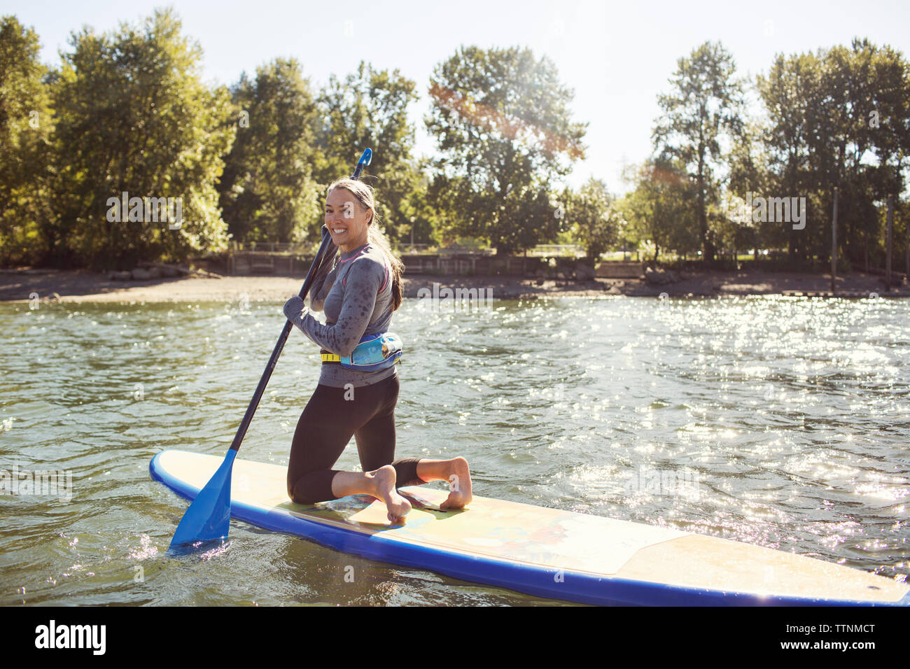Smiling woman holding paddle hi-res stock photography and images - Alamy