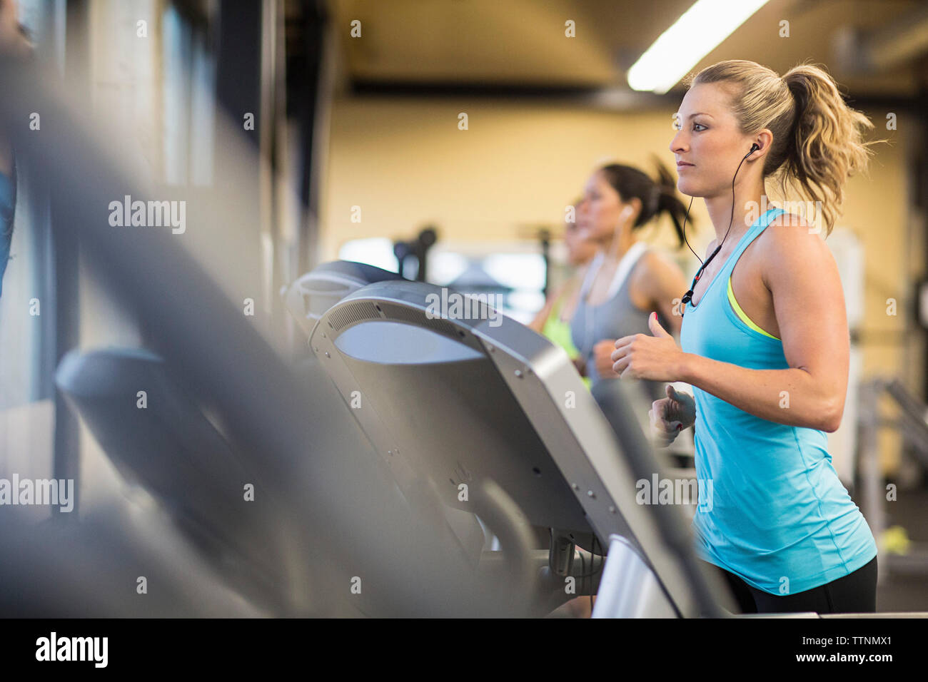 Women exercising on treadmills in gym Stock Photo - Alamy