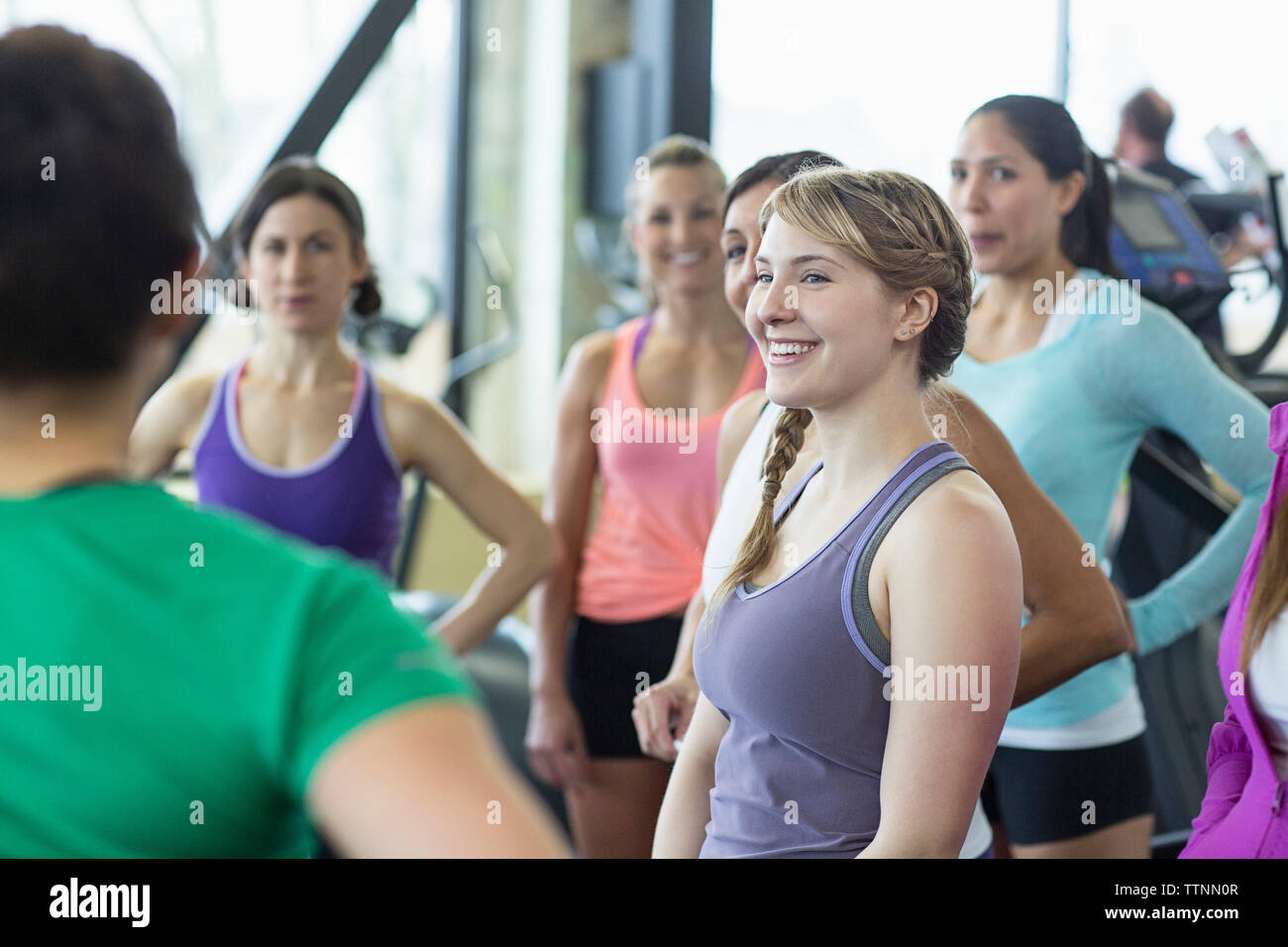 Coach instructing women in gym Stock Photo - Alamy