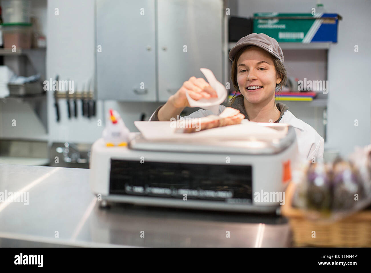 Smiling worker making food while working at supermarket Stock Photo - Alamy