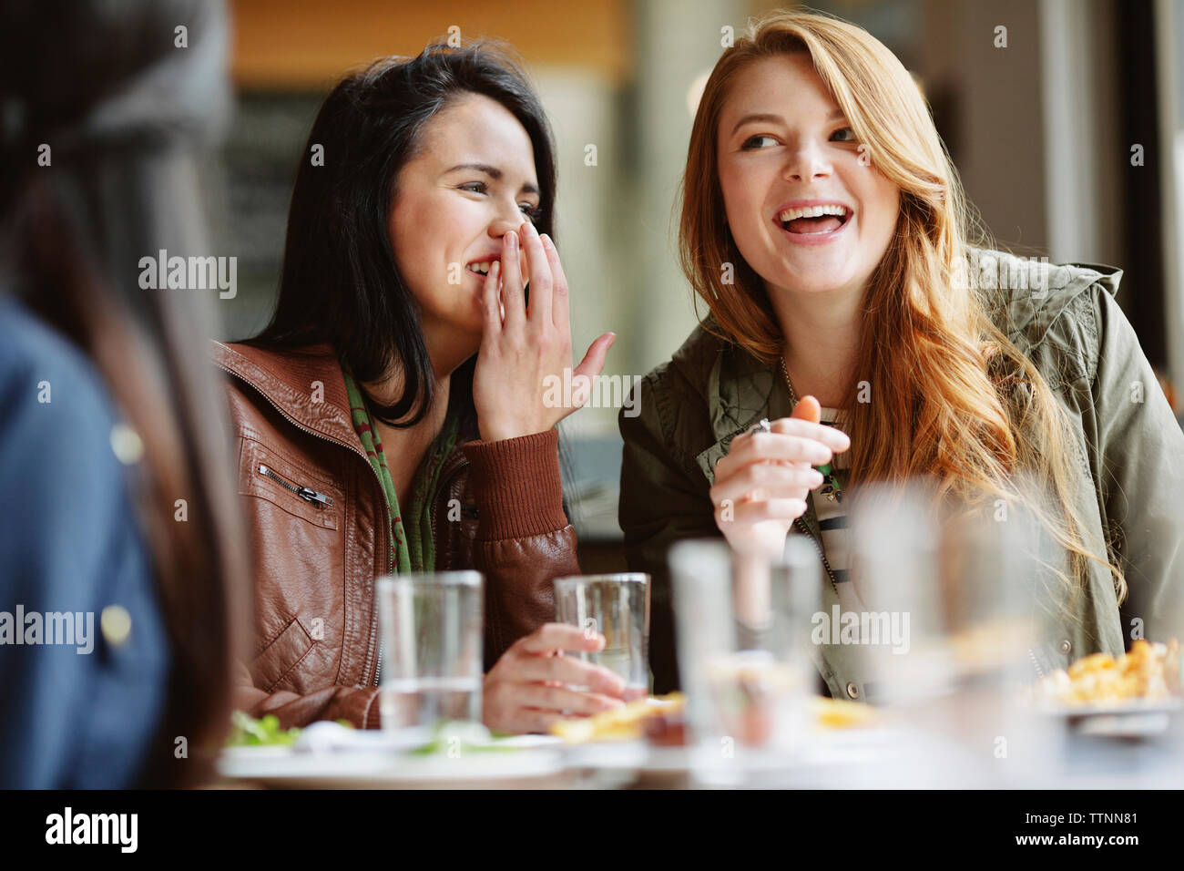 Women laughing restaurant table hi-res stock photography and images - Alamy