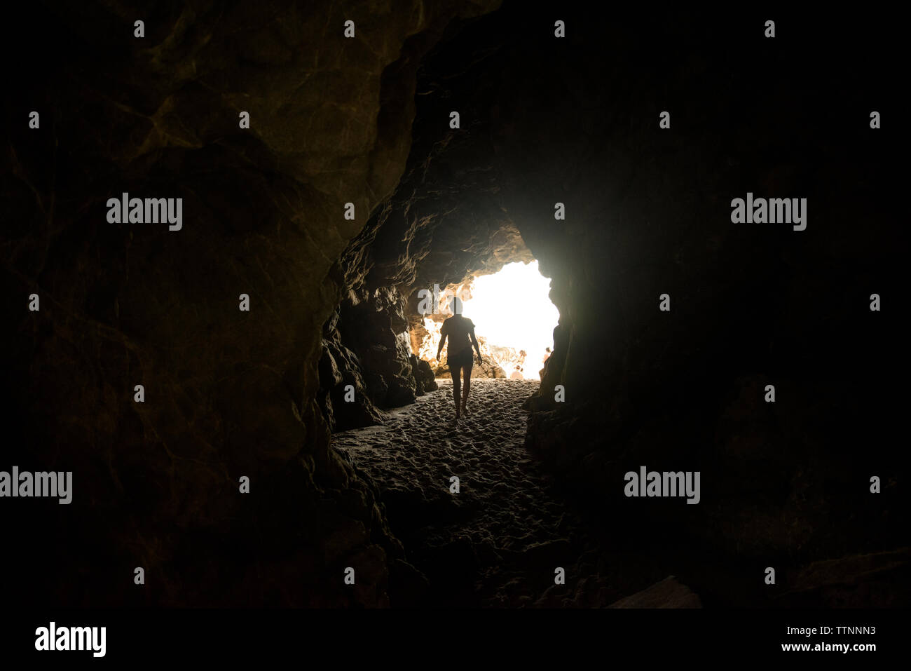 Woman walking in cave hi-res stock photography and images - Alamy