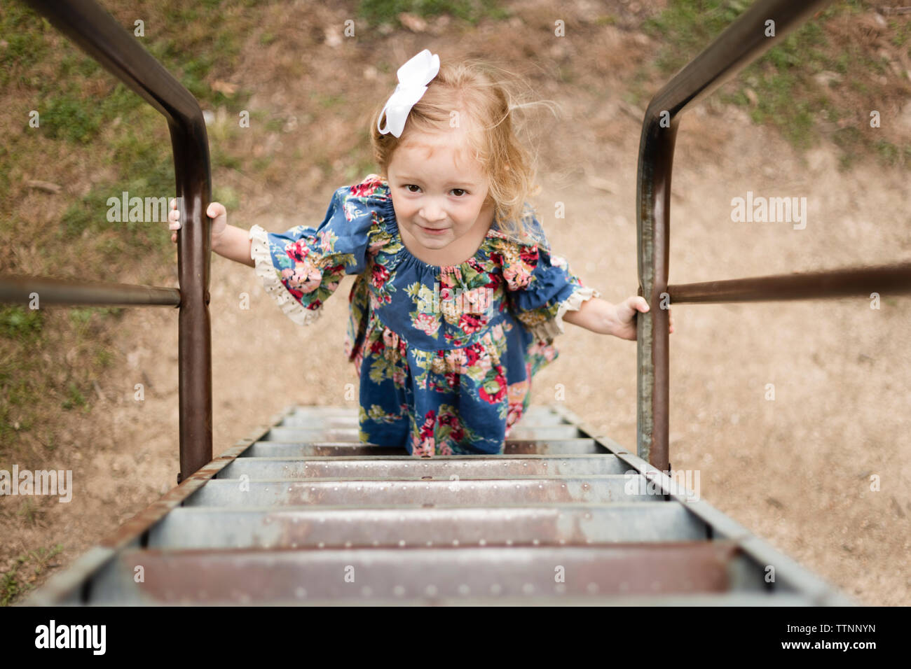 High angle portrait of girl standing on slide steps Stock Photo - Alamy