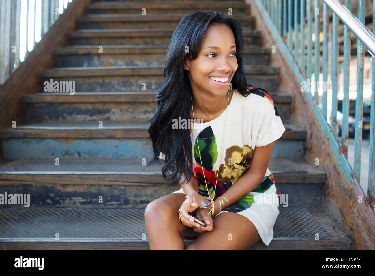 Young woman sitting staircase hi-res stock photography and images - Alamy