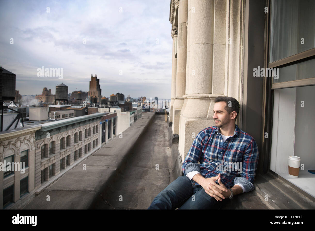 Man sitting on balcony hi-res stock photography and images - Alamy