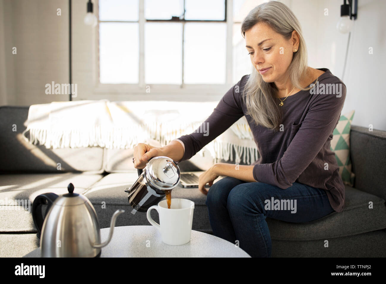 Woman pouring coffee hi-res stock photography and images - Alamy