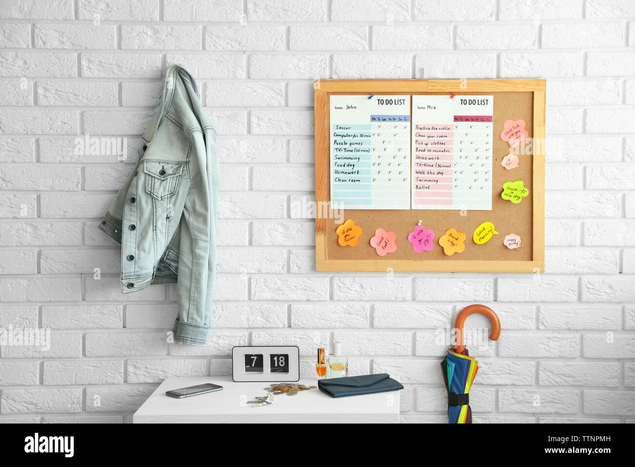 Wooden board with to do list hanging on white brick wall Stock Photo ...