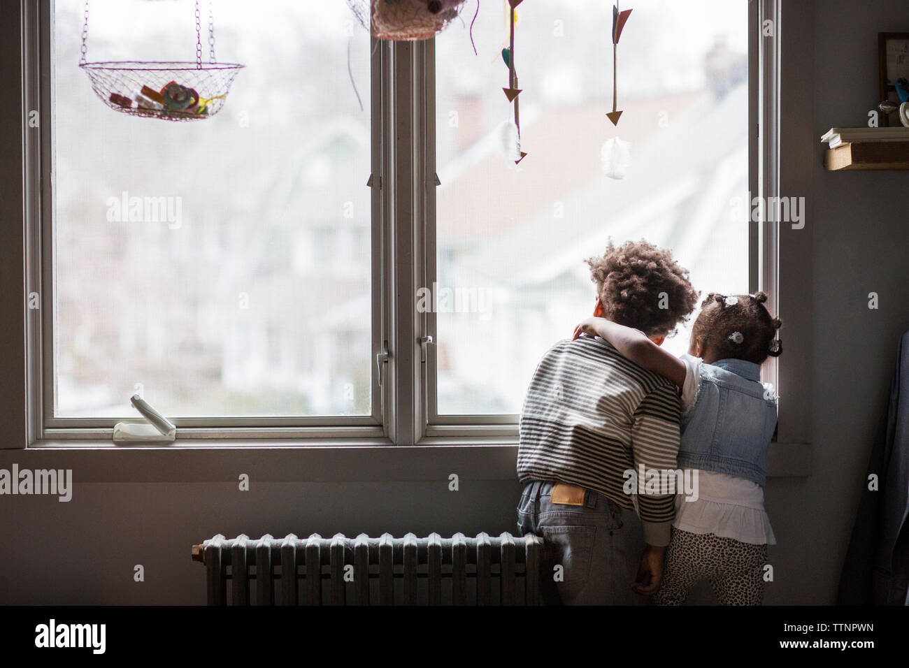 Brother sister hugging rear view hi-res stock photography and images ...