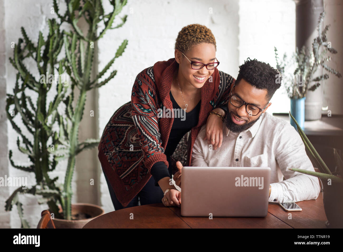 Smiling young couple sharing hi-res stock photography and images - Alamy