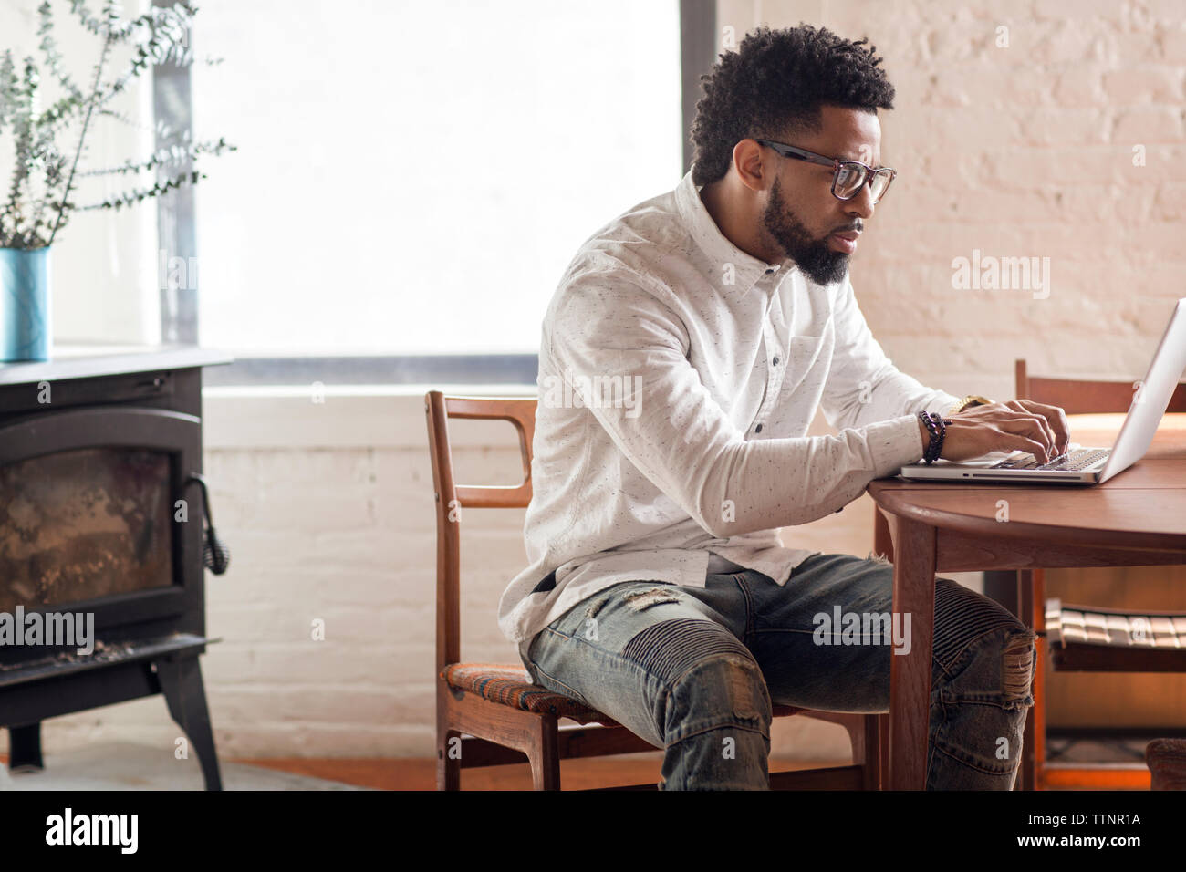 Young man using laptop at home Stock Photo - Alamy