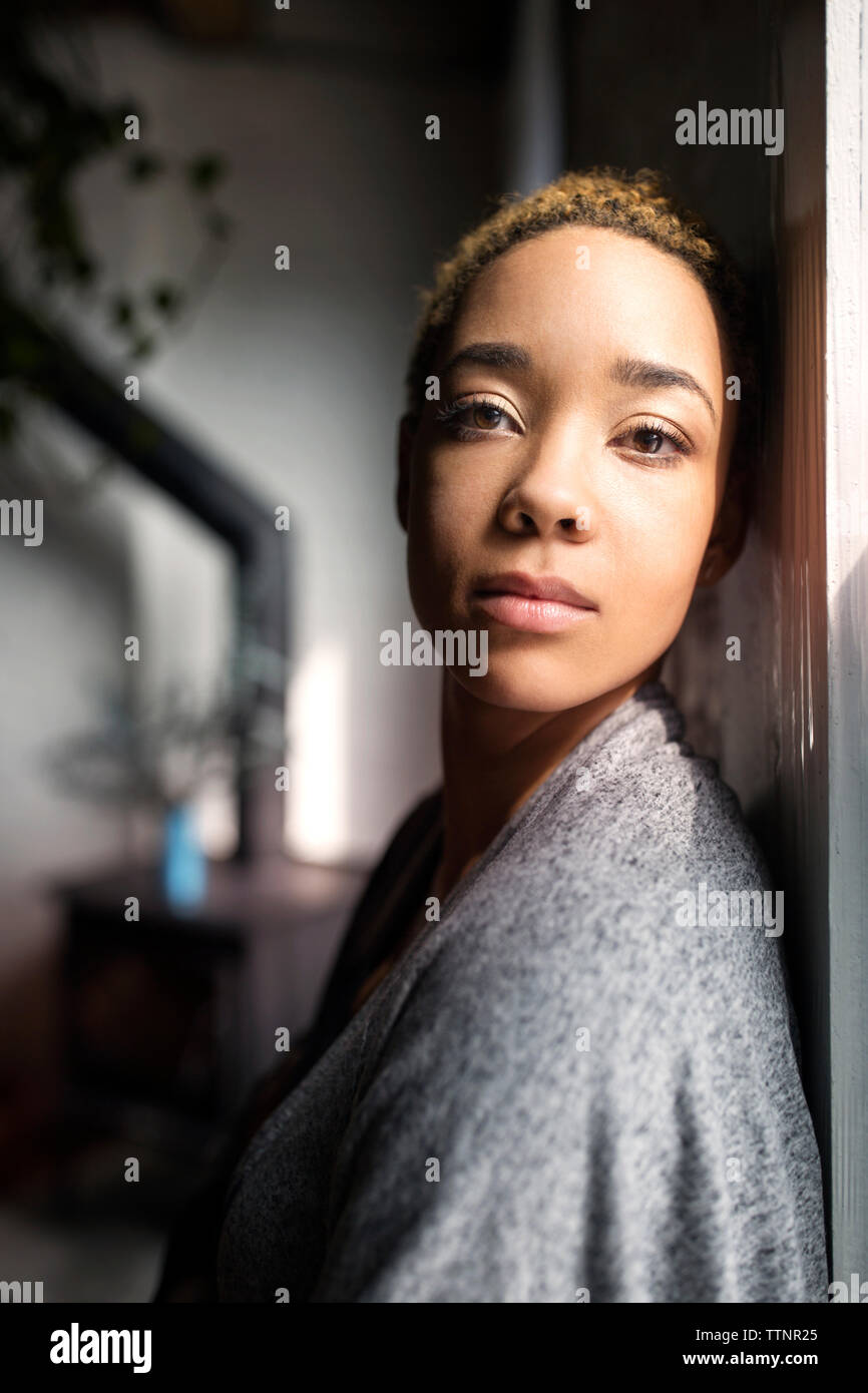 Side view portrait of serious young woman at home Stock Photo - Alamy