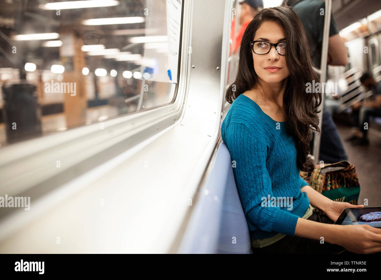 Young woman looking through train window Stock Photo - Alamy