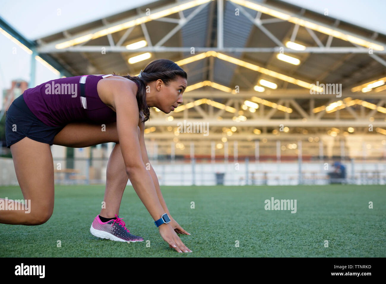 Athlete running on field Stock Photo - Alamy