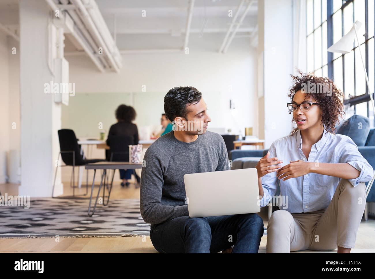 business people talking while using laptop computer in office Stock ...