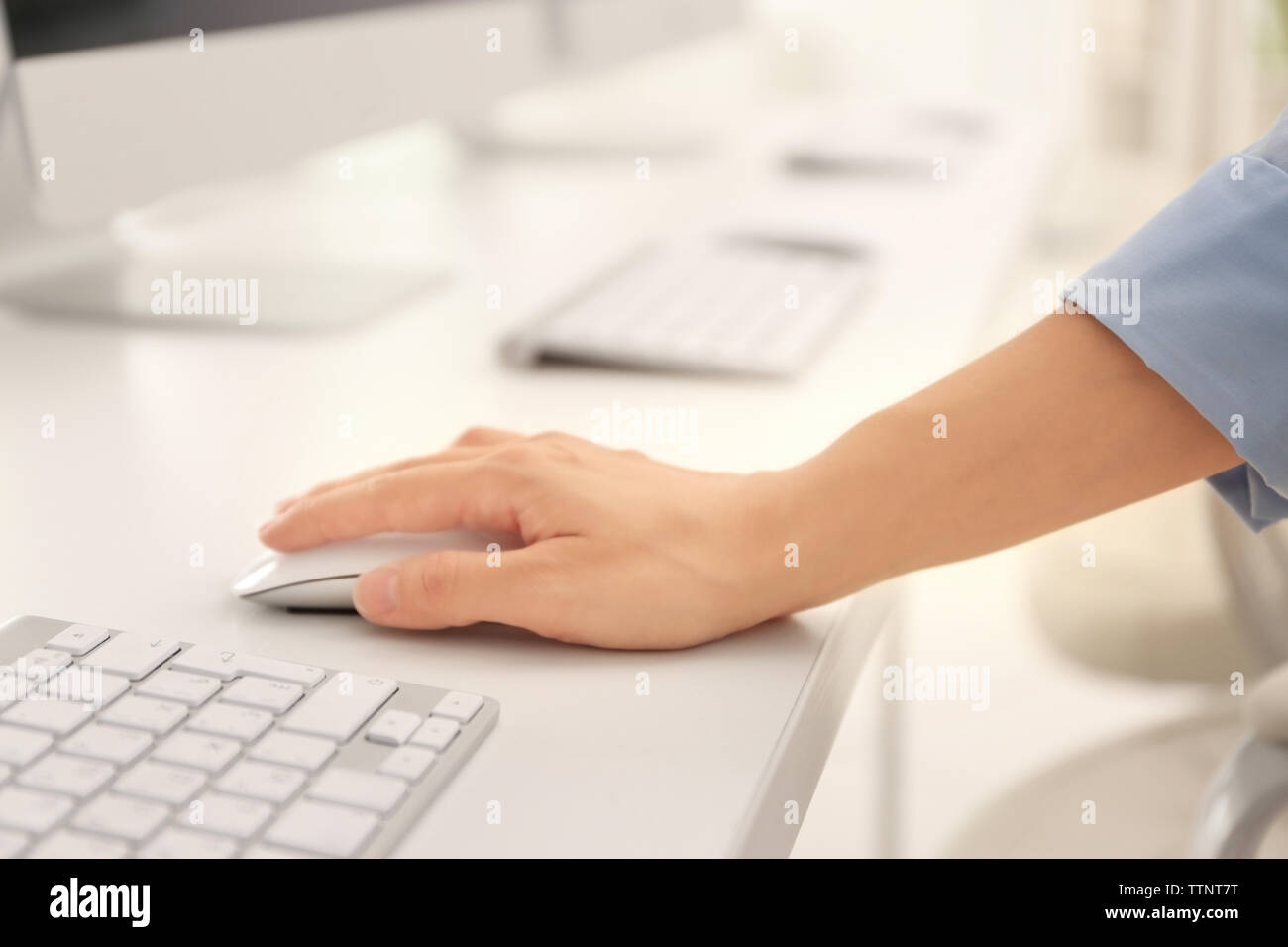 Female hand holding mouse while working on computer Stock Photo - Alamy