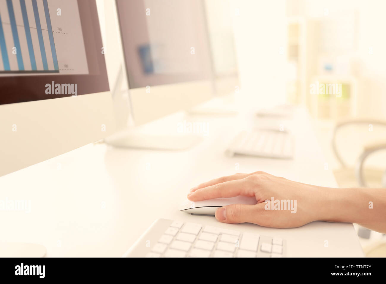 Female hand holding mouse while working on computer Stock Photo - Alamy